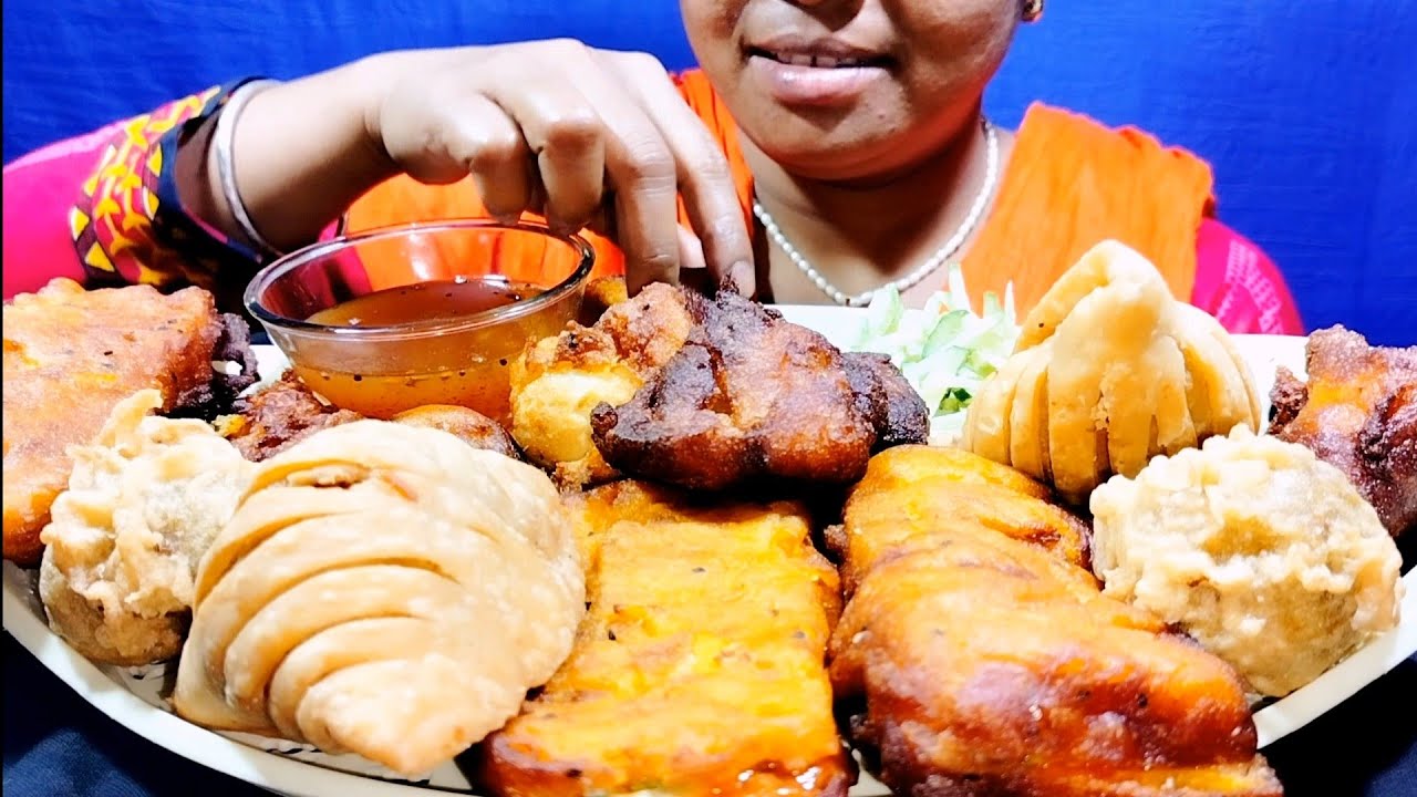eating chowmin samosa, chicken pakoda, bread patties,egg Chop ...