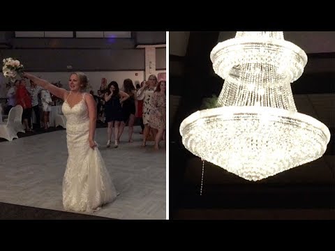 Bride Throws Bouquet Onto Chandelier