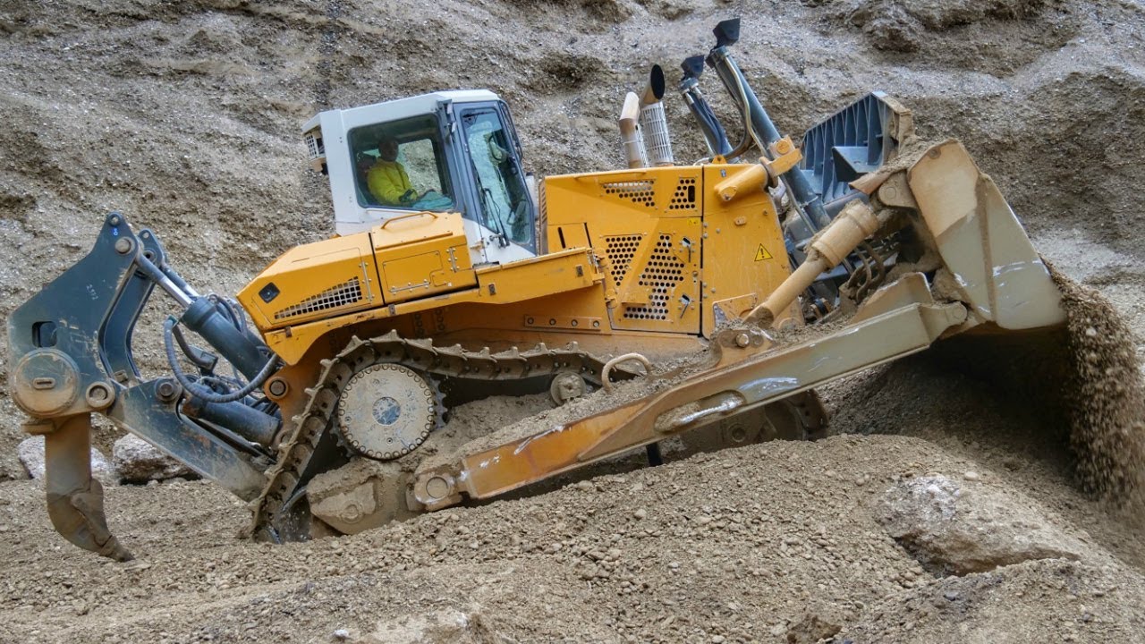 Prototype Liebherr PR776 dozer pushing boulders and gravel - YouTube