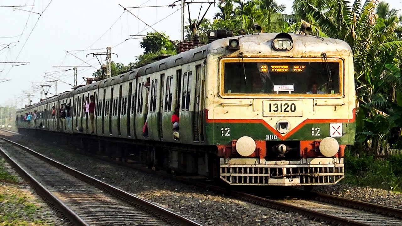 EMU Local Train entered through a curve to the station & lots of people ...