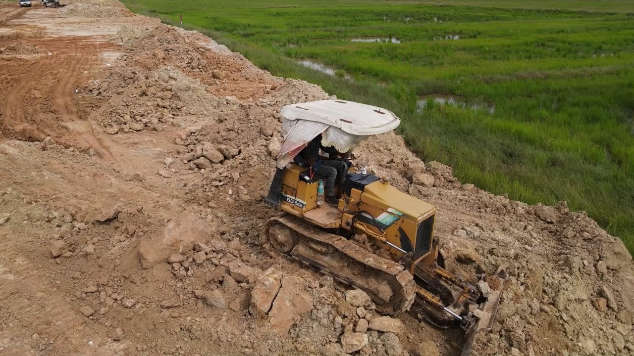 Strongly Old Mini Dozer filling up by pushing rock operated with 5 ton ...