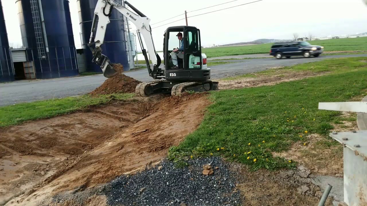 Bobcat e55 creating drainage ditch - YouTube