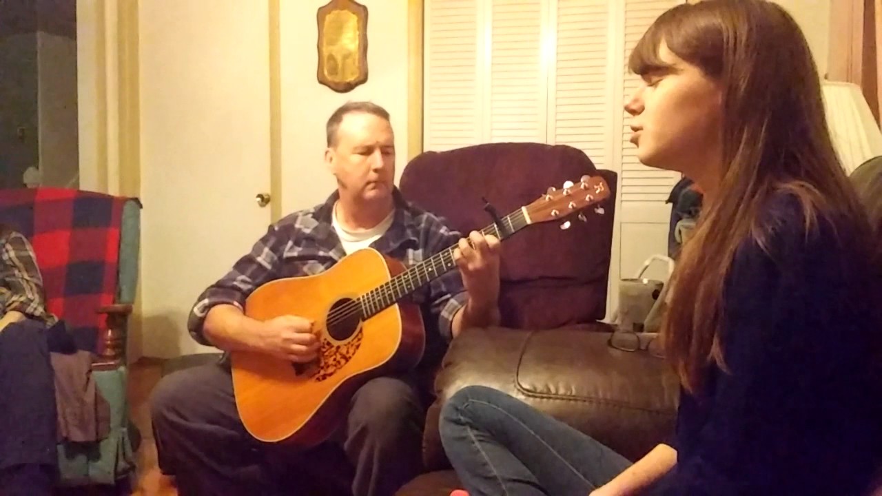 Amanda Vaughn singing, her father Ronald Vaughn playing the guitar ...
