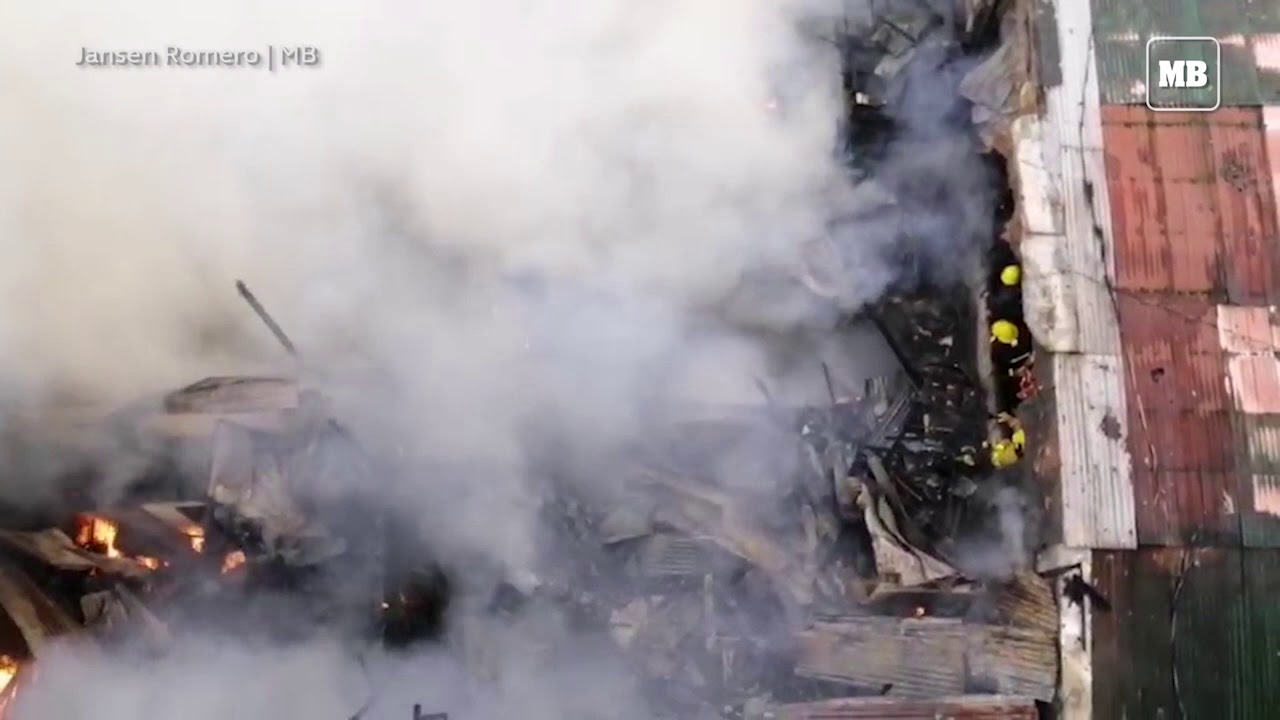 Billows of smoke engulf as firefighters extinguish the fire that razed ...