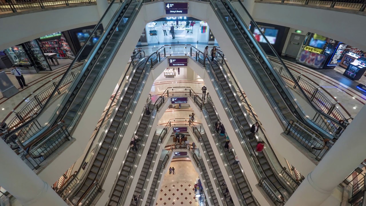 timelapse high angle shot of modern multistorey shopping mall people ...