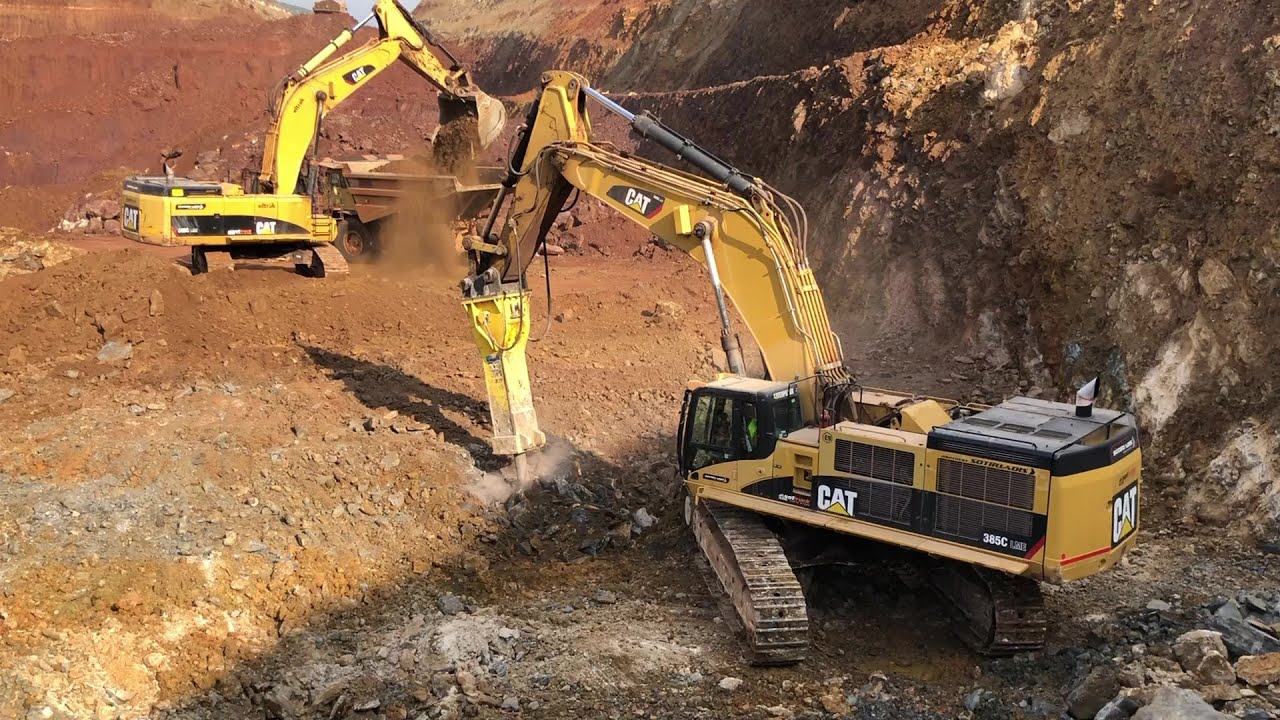 Two Caterpillar 385C Excavators With Bucket & Hammer Working On Quarry ...