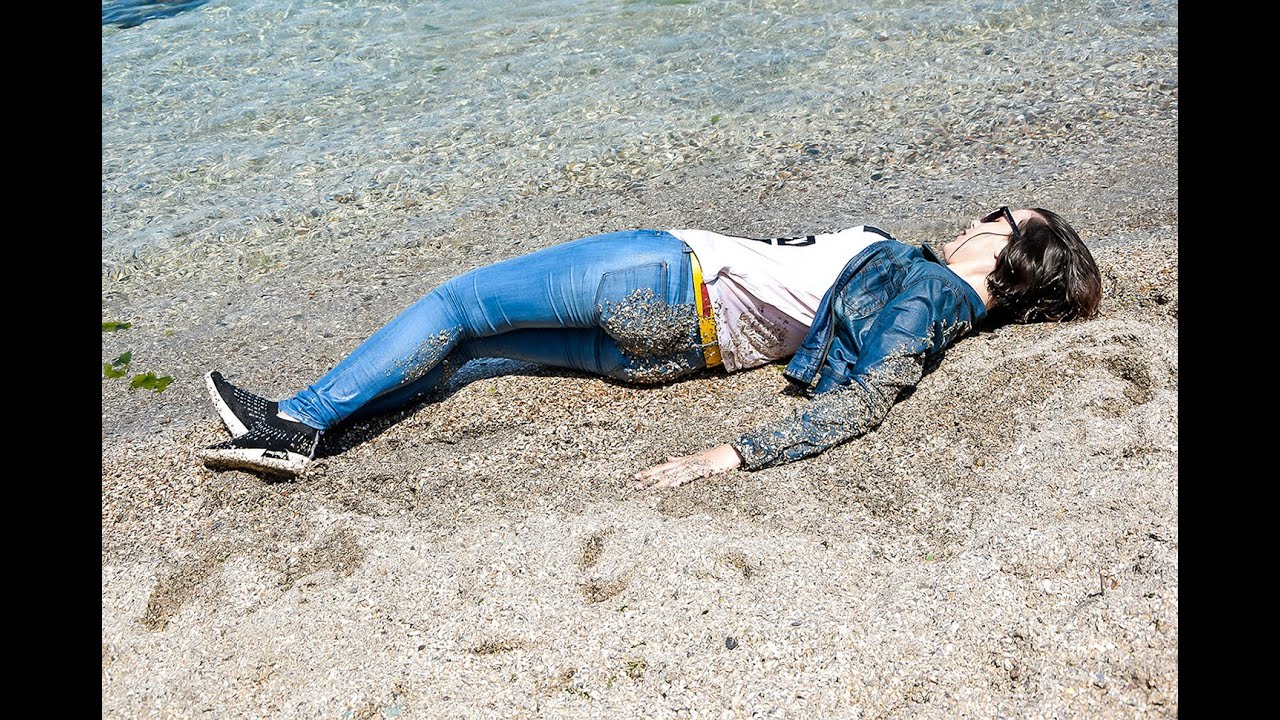beautiful model in wet denim jacket and wet jeans poses interestingly ...