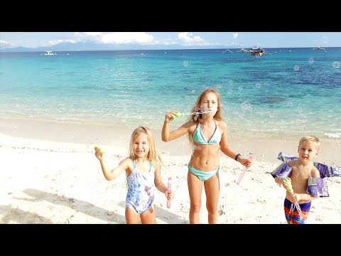 Children playing on the beach with soap bubbles 4k