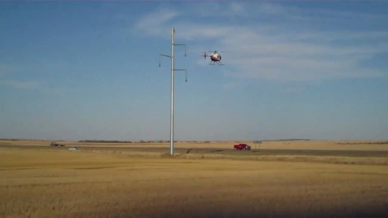 Threading in High Voltage Power Lines with a Helicopter - YouTube