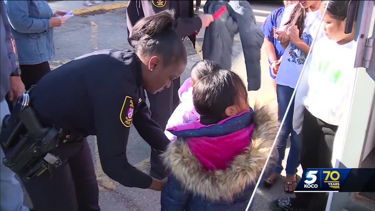 Moore police officers hand out coats to families in need - YouTube