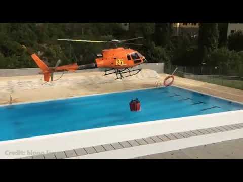 Firefighter helicopter picks up water from the swimming pool - YouTube