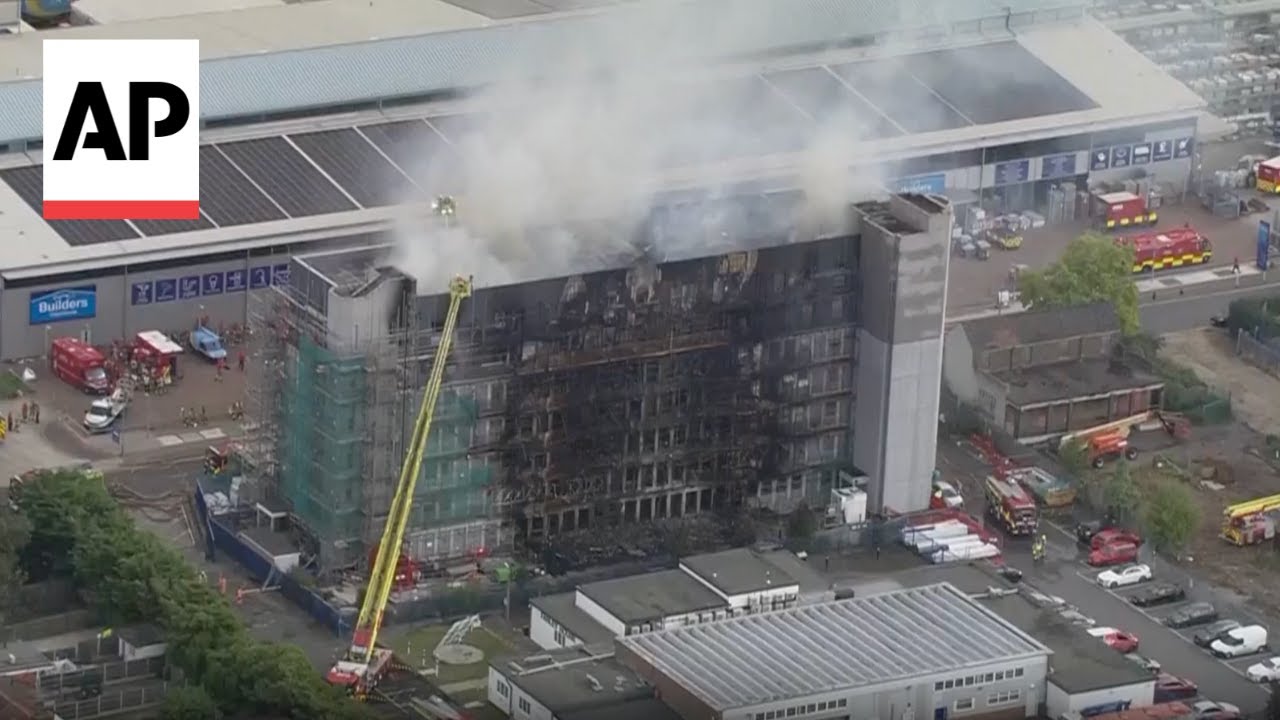 Fire engulfs apartment building in east London - YouTube