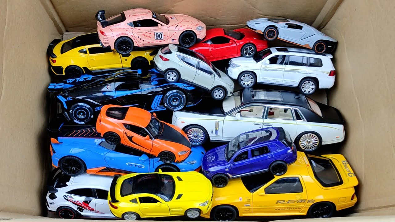 Box full of various miniature cars Jaguar, Peugeot, Renault, Hyundai ...