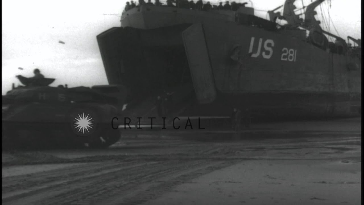 M4 Sherman tanks move to a beach from a US Navy LST (Landing Ship, Tank ...
