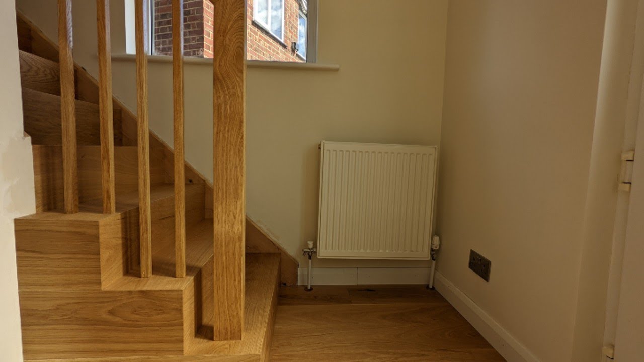Honey coloured engineered oak boards with feature staircase & custom ...