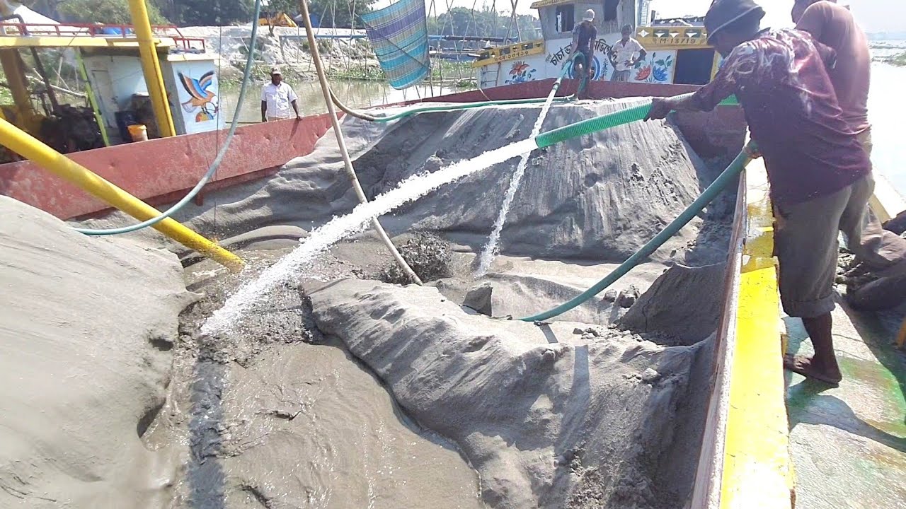 Unload sand from big ship by powerful drager machine and three face ...