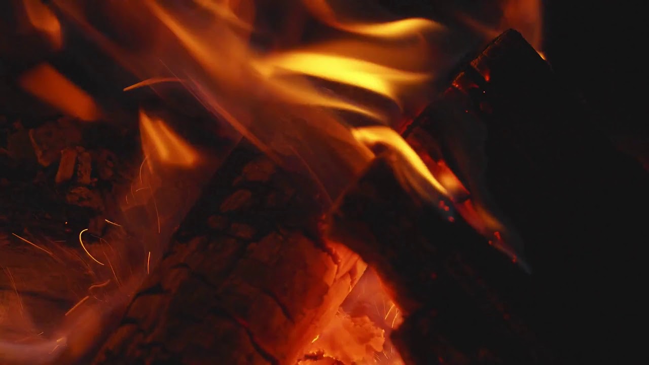 open fire close up burning logs atmosphere of heat the background ...