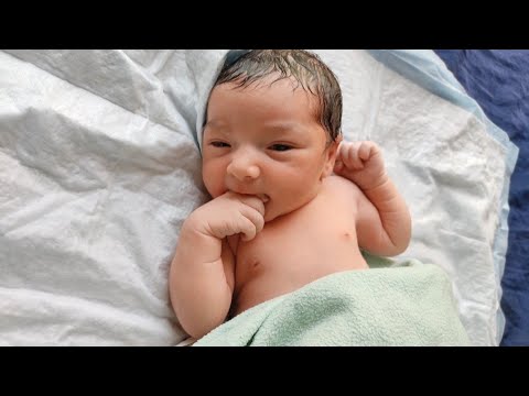 A smiling Beautiful Newborn baby just after birth