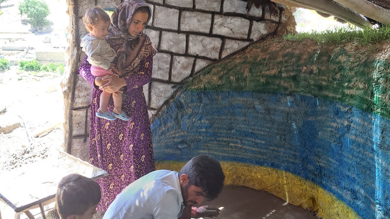 Painting the wall and cementing the floor of a small nomadic house ...