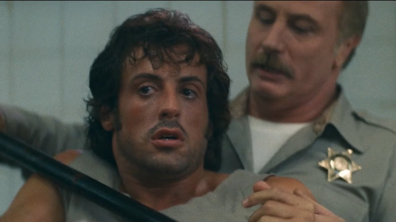 Rambo is beaten up by a police officer at the police station. Sylvester ...