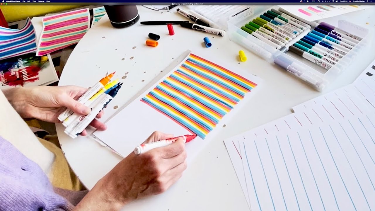 Drawing rainbow horizontal stripes on paper with felt tip pens to make ...