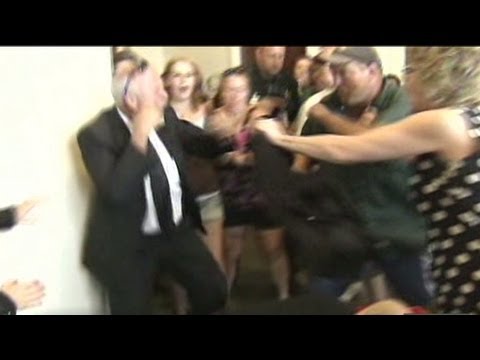 Watch fists fly during courthouse brawl - YouTube