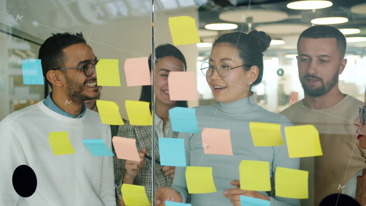 Cheerful people colleagues working in office with sticky notes talking ...