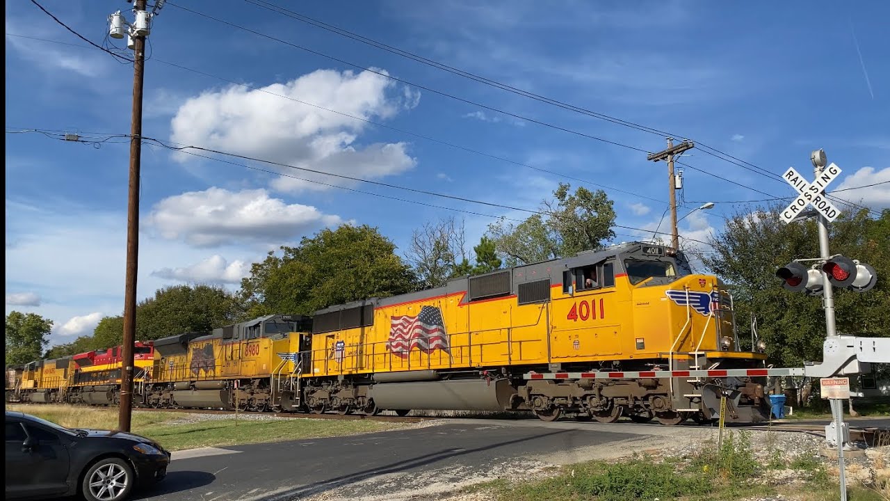 Union Pacific freshly panted SD70M 4011 leads five engines with a KCS ...