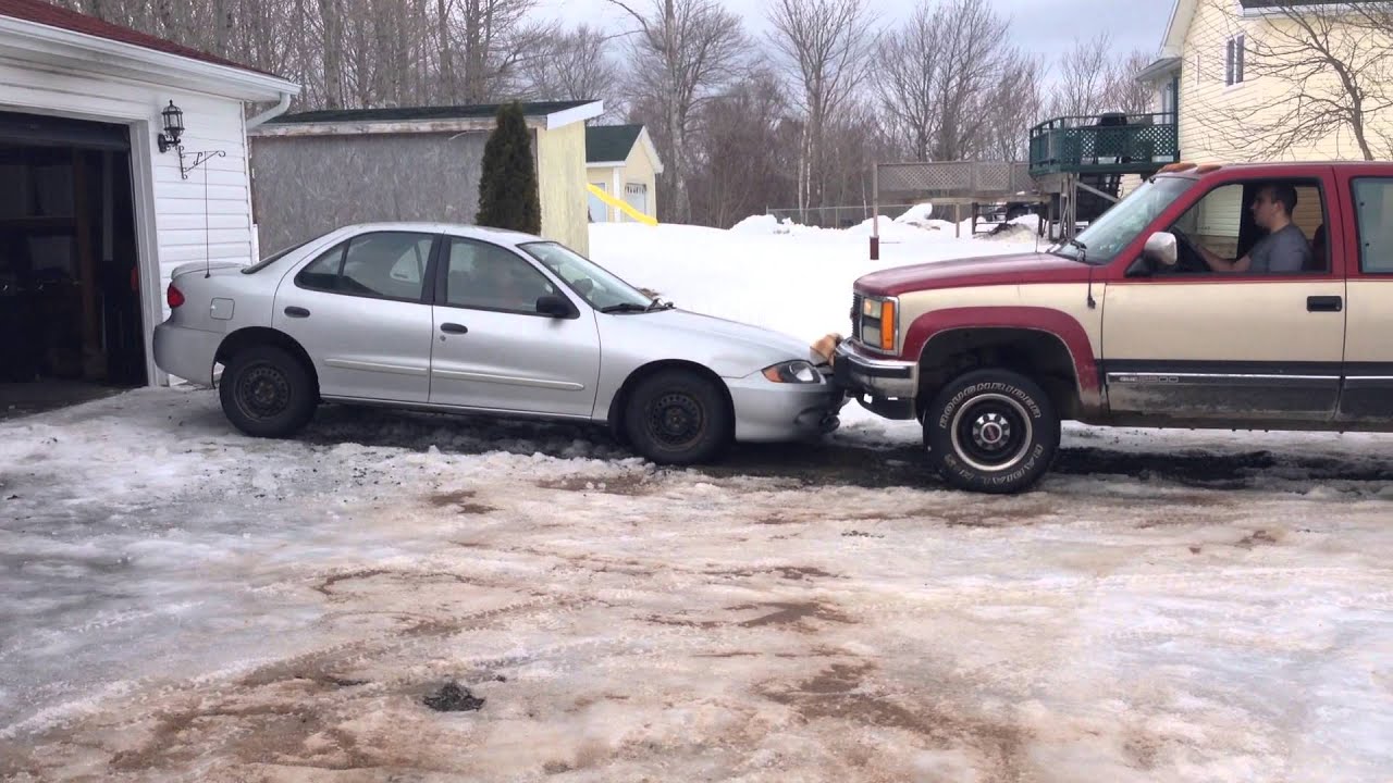 1992 GMC truck pushing broken down Chevy Cavalier into garage - YouTube