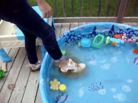 Girl DC shoes and socks mudding Then cleaning in pool