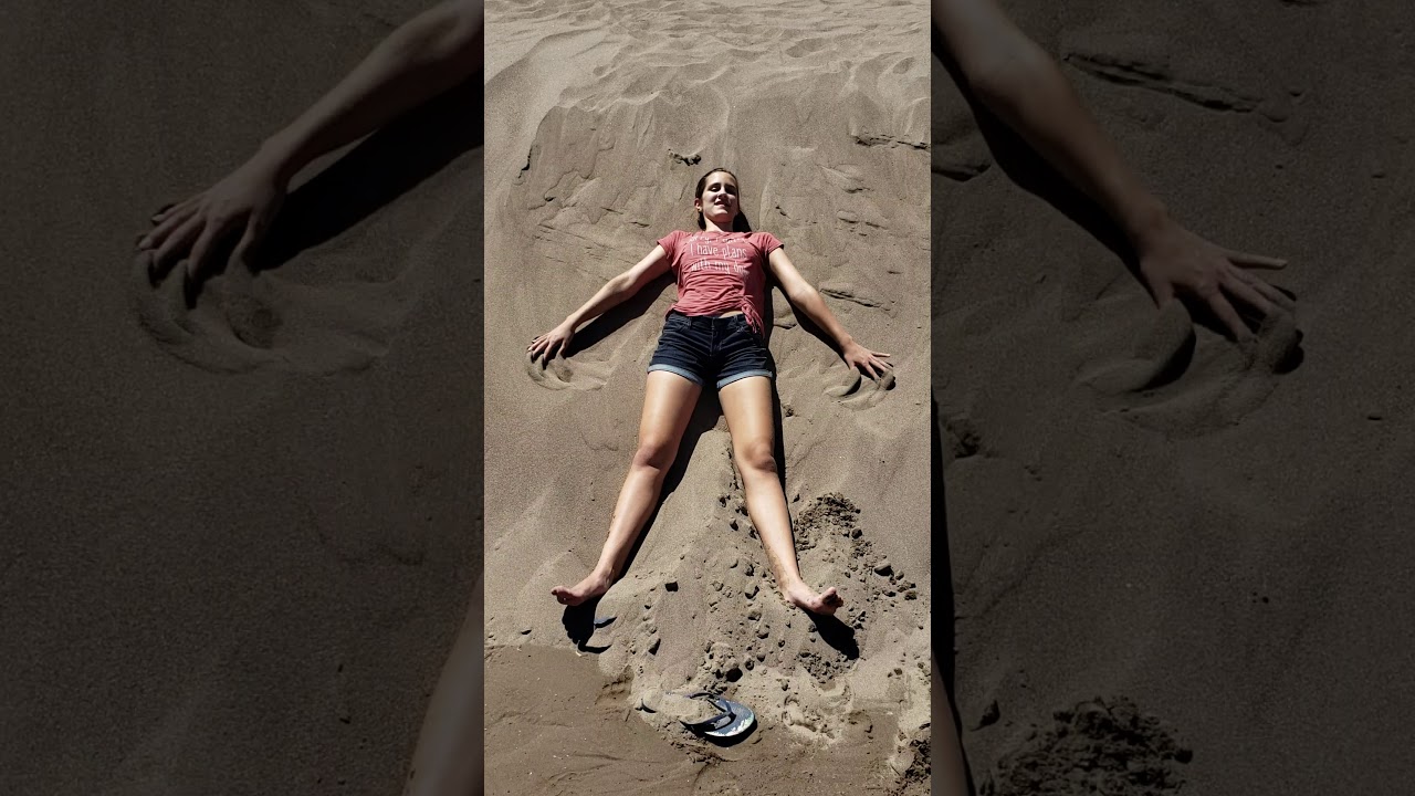 Audrey makes a Sand Angel - YouTube