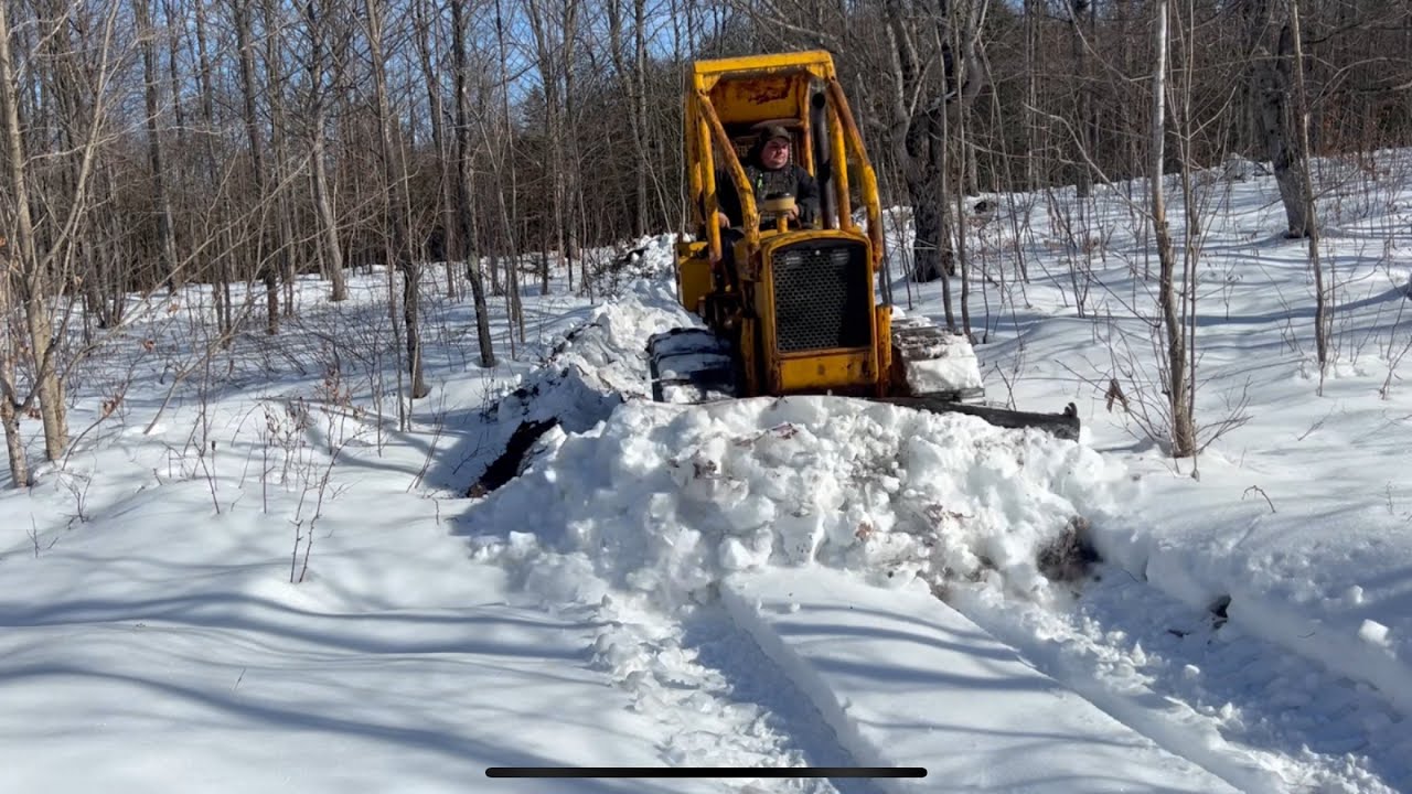 Bulldozer plowing deep hard packed snow - YouTube
