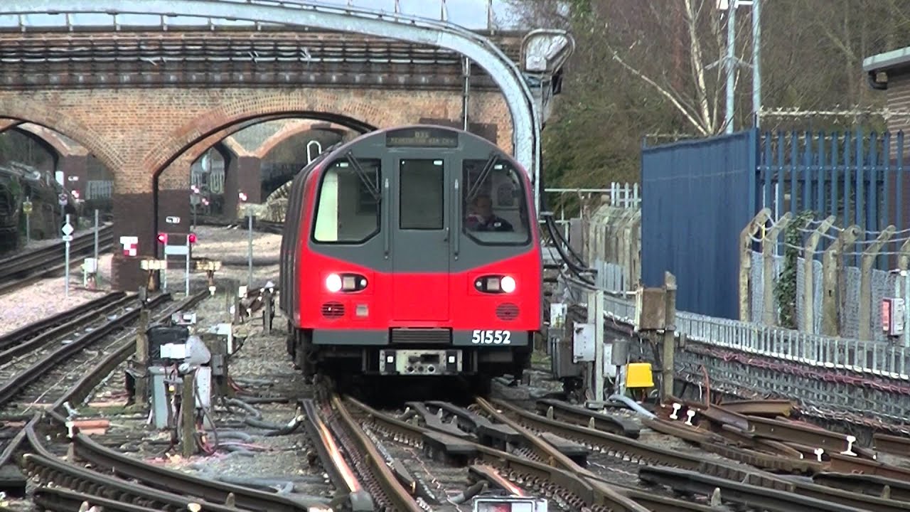 London Underground 1995 Stock 51552 and 55530 arriving into East ...