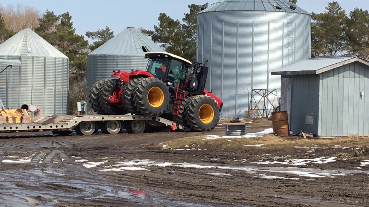 Unloading a BIG @$$ versatile tractor from trailer - YouTube