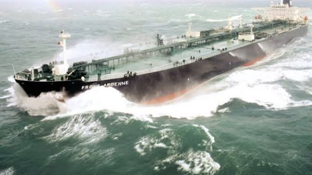 Giant oil tanker, container ship overcoming fierce waves in stormy ...