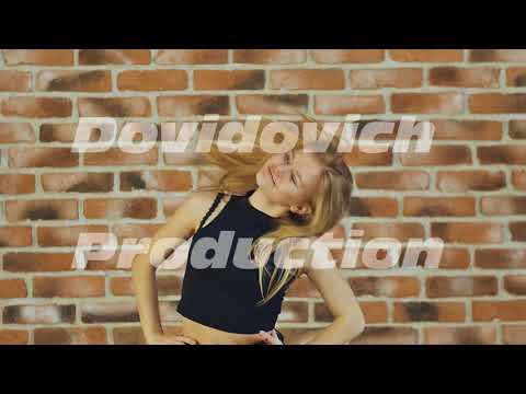 Hip hop blonde girl dancing in modern style over urban brick wall. Slow motion