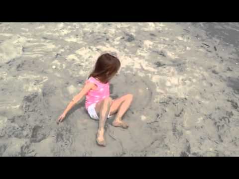 Maddy making a sand angel - YouTube