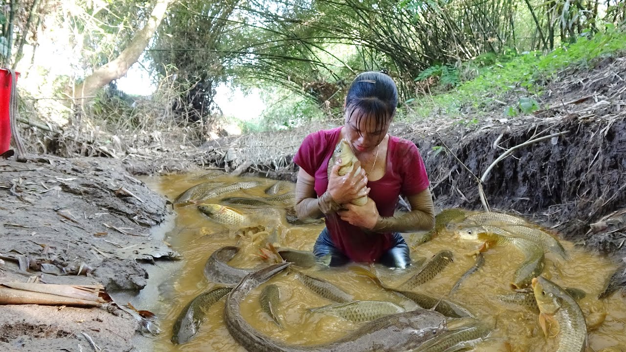 It was amazing the girl caught a lot of fish in a puddle in a dry ...