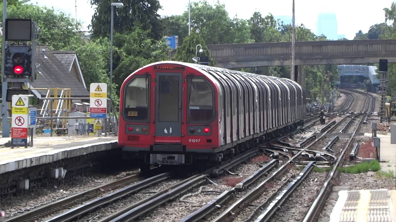 Central Line trains arriving and departing Woodford - YouTube