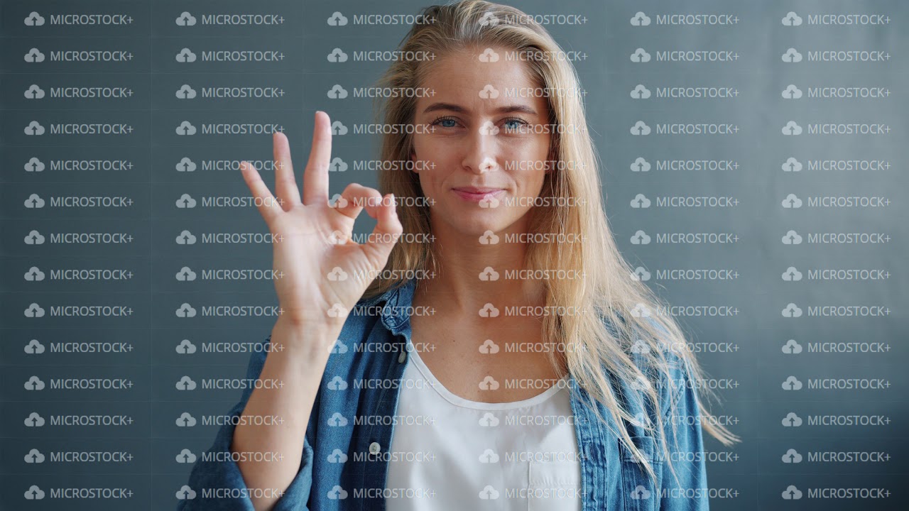 Portrait of good-looking lady showing okay sign on gray background ...