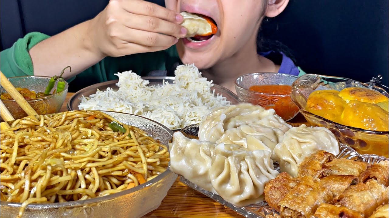 Eating garlic noodles, vegetable momos spring rolls egg curry with rice ...
