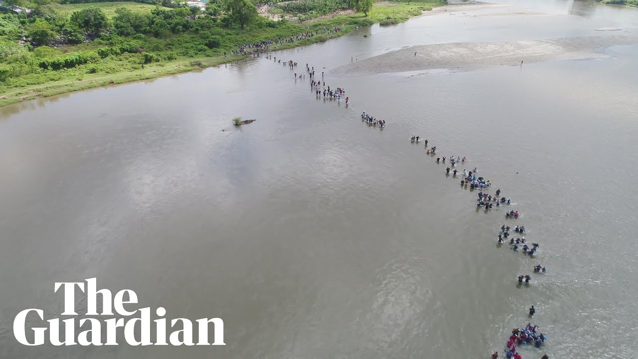 Caravan of migrants crosses river from Guatemala to Mexico - YouTube