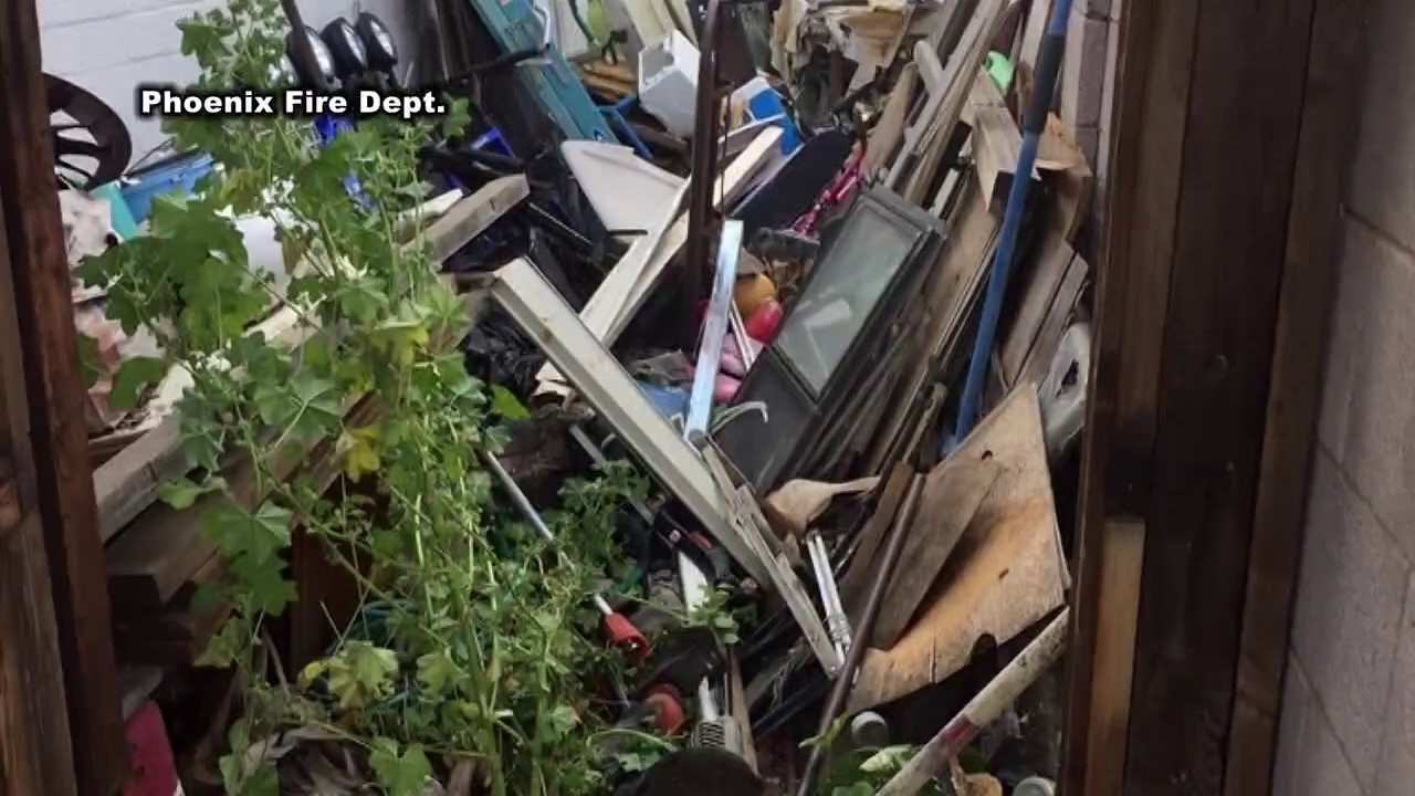 Firefighters fight flames at hoarder house - YouTube