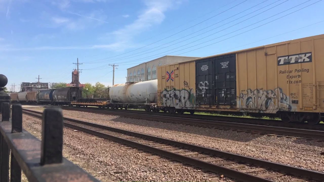 Freight train meets metra - YouTube