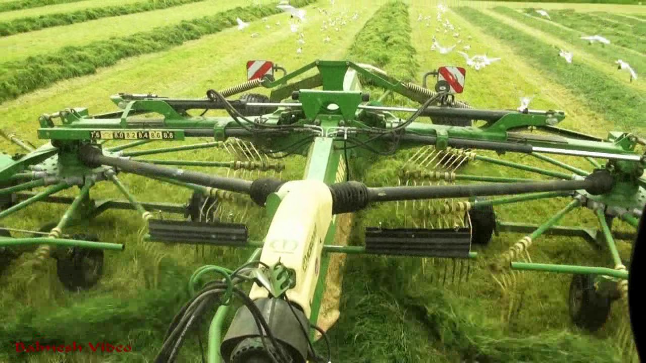 Raking for Silage with NEW Krone - and Cab View. Can they beat the rain ...