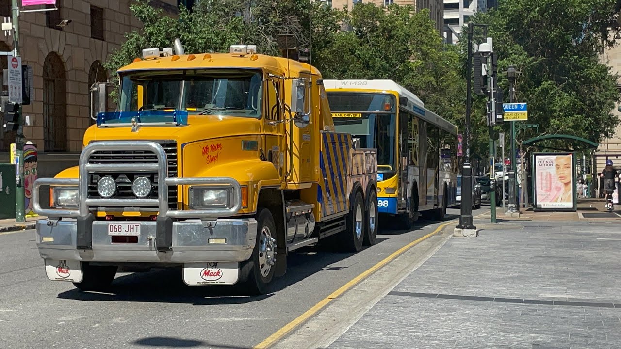A bus getting towed by a tow truck in Brisbane - YouTube