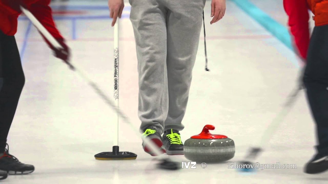 Curling stone slide, players sweeping - YouTube