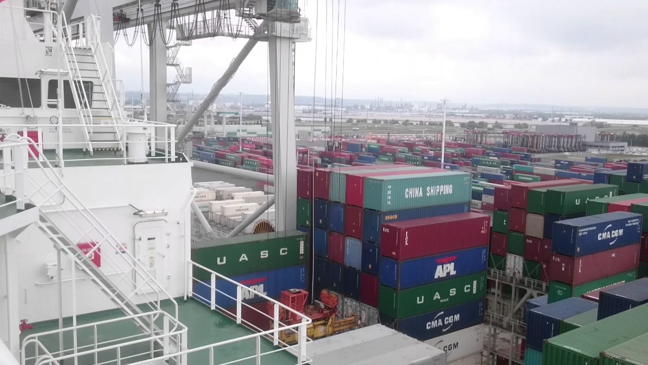 Container ship gear boxes going back on ship - YouTube