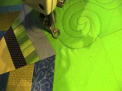 long arm quilting a spider web quilt with swirls - YouTube