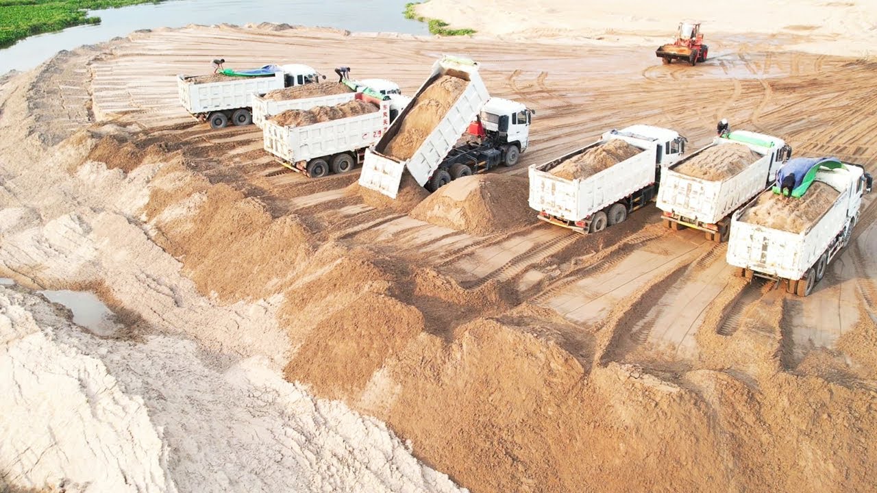 Large Amount Dump Truck Unloading Sand Filling Up Wheel Loader ...